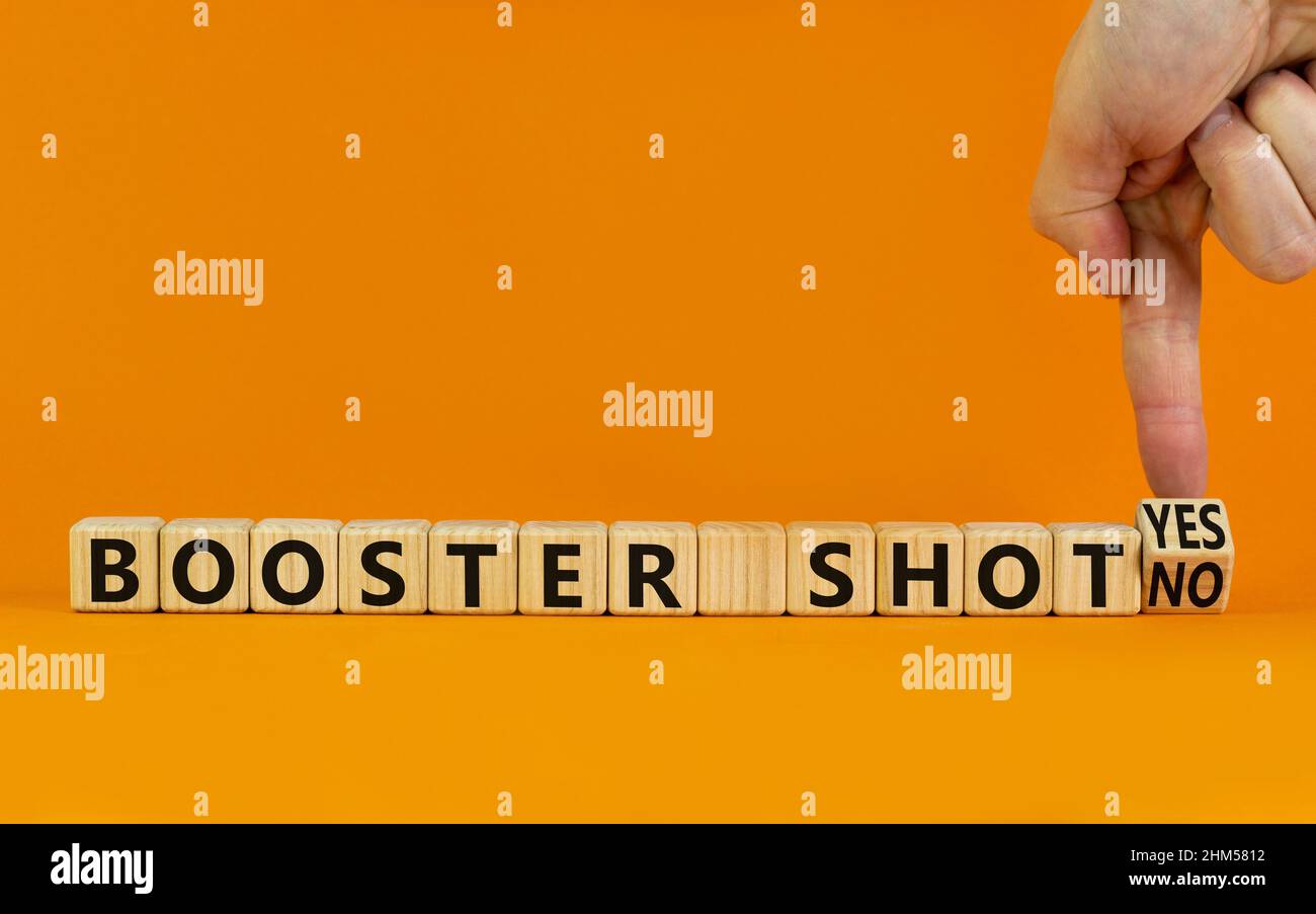 Covid-19 booster vaccine shot yes or no symbol. Doctor turns cubes and ...
