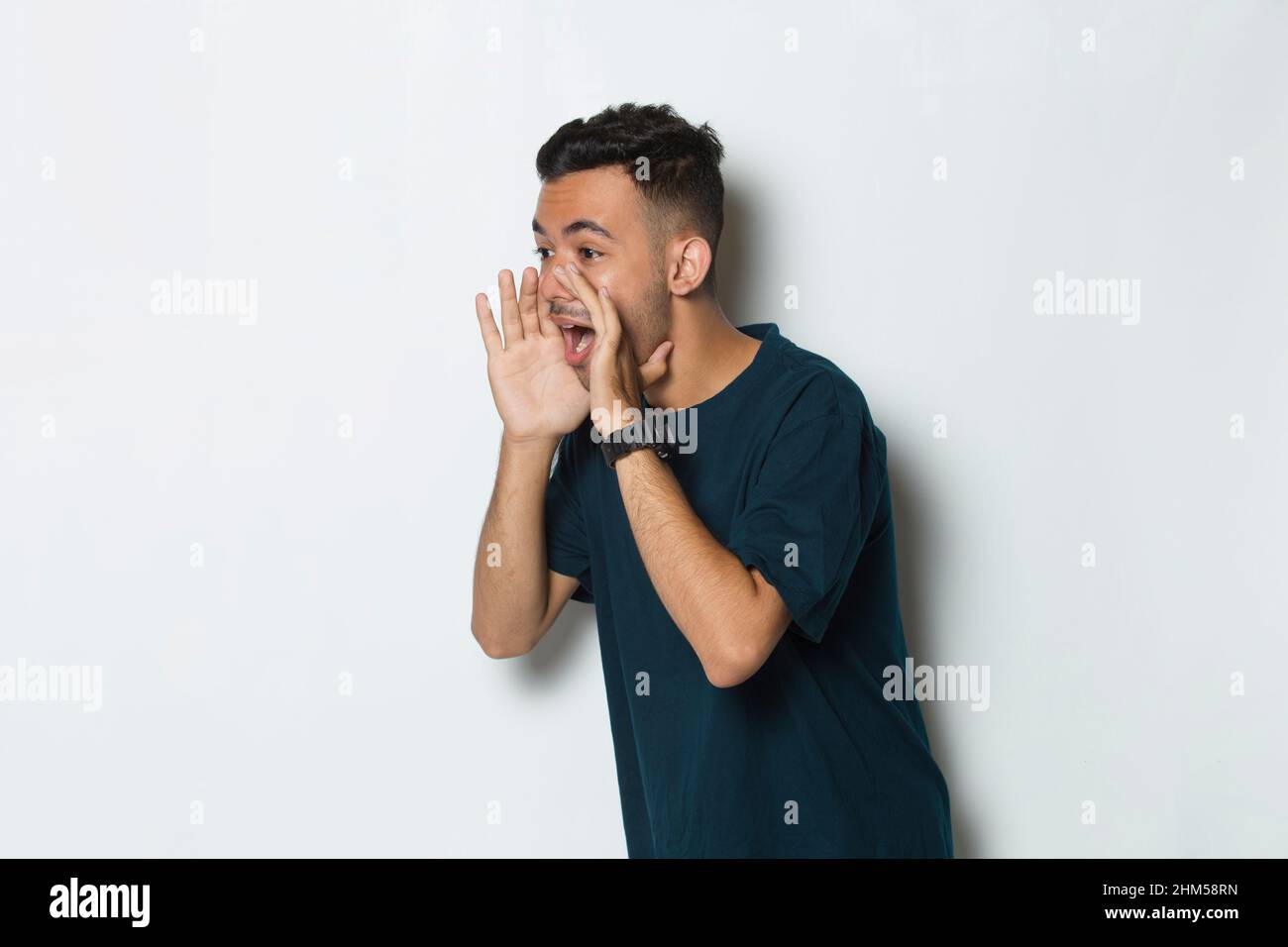young handsome man shouting and yelling announcing isolated on white ...