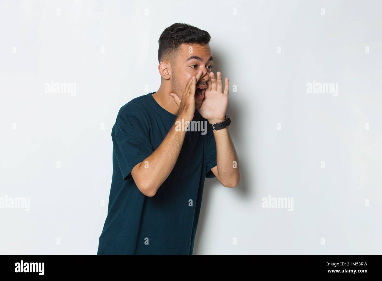 young handsome man shouting and yelling announcing isolated on white ...
