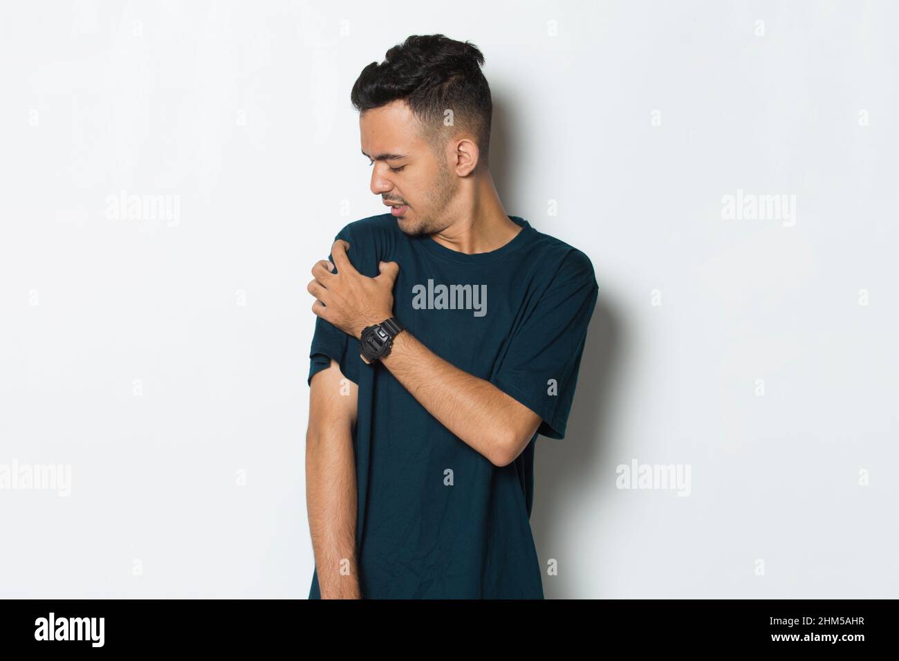 Young man scratching arm allergy itchy skin isolated on white ...