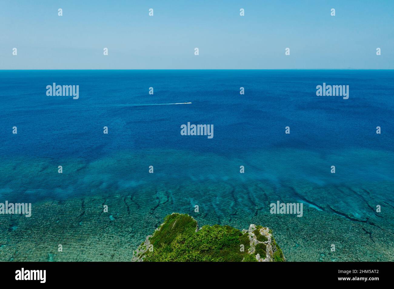 Boat crosses the ocean near coral reefs with blue sky Stock Photo - Alamy