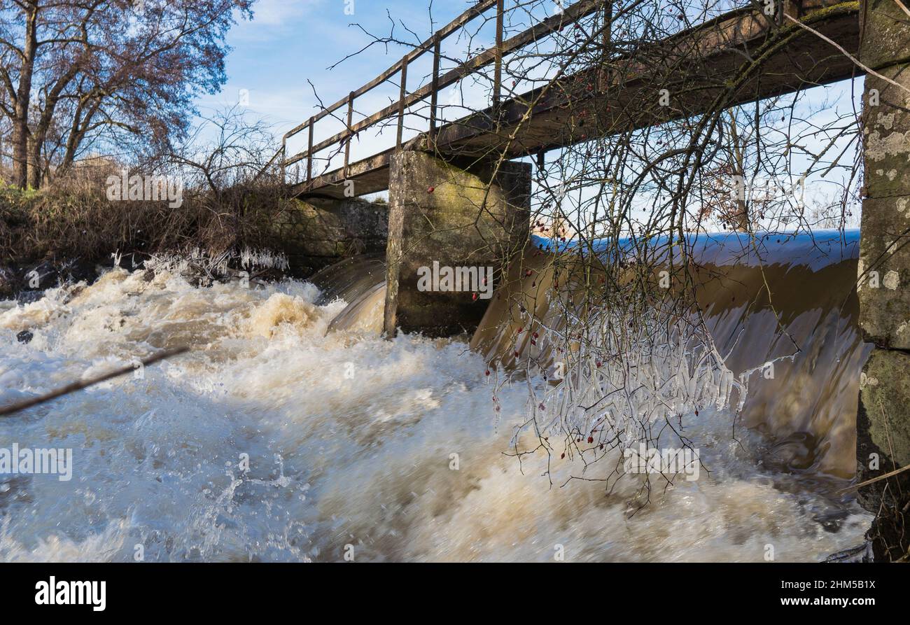 old bridge over a weir on a small river Stock Photo - Alamy