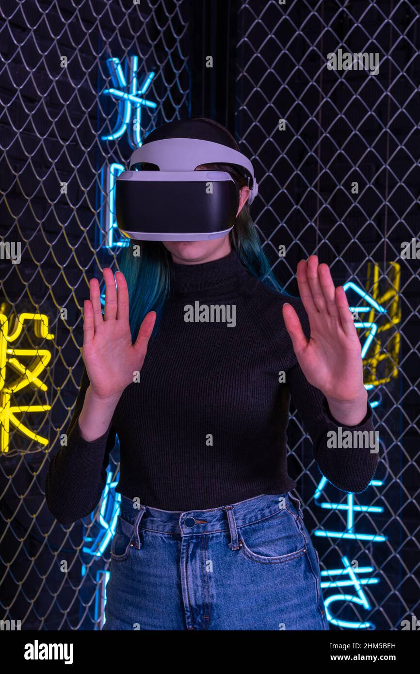 Teen girl using vr headset is in virtual reality cyberspace futuristic ...
