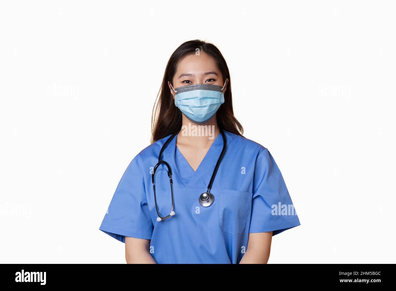 Studio portrait of an asian doctor with a face mask looking at the ...
