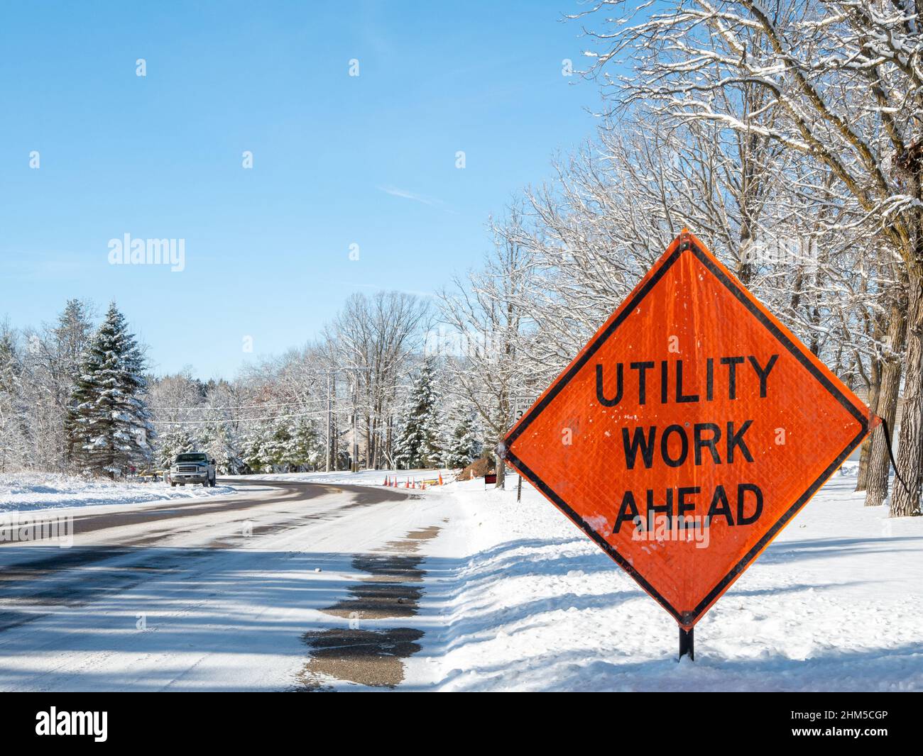 UTILITY WORK AHEAD sign warns traffic about a work zone on winter ...