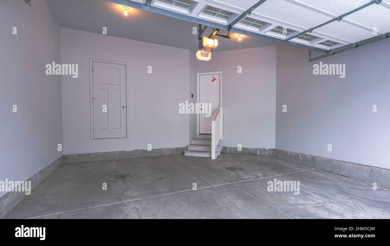 Panorama Interior of a garage with over the canopy garage door with ...