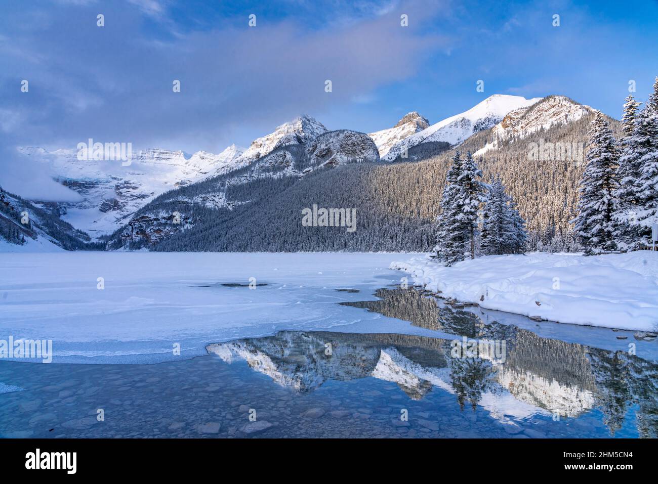 A view of a partially frozen Lake Louise in winter, Banff National Park ...