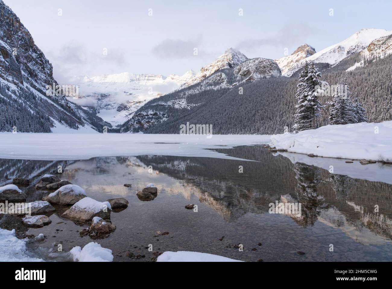 A view of a partially frozen Lake Louise in winter, Banff National Park ...
