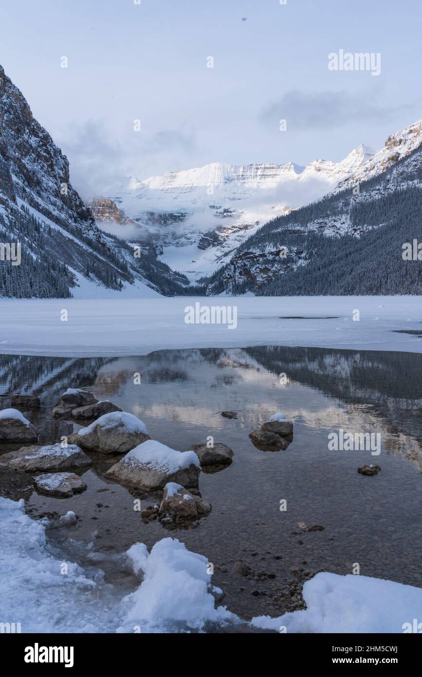 A view of a partially frozen Lake Louise in winter, Banff National Park ...