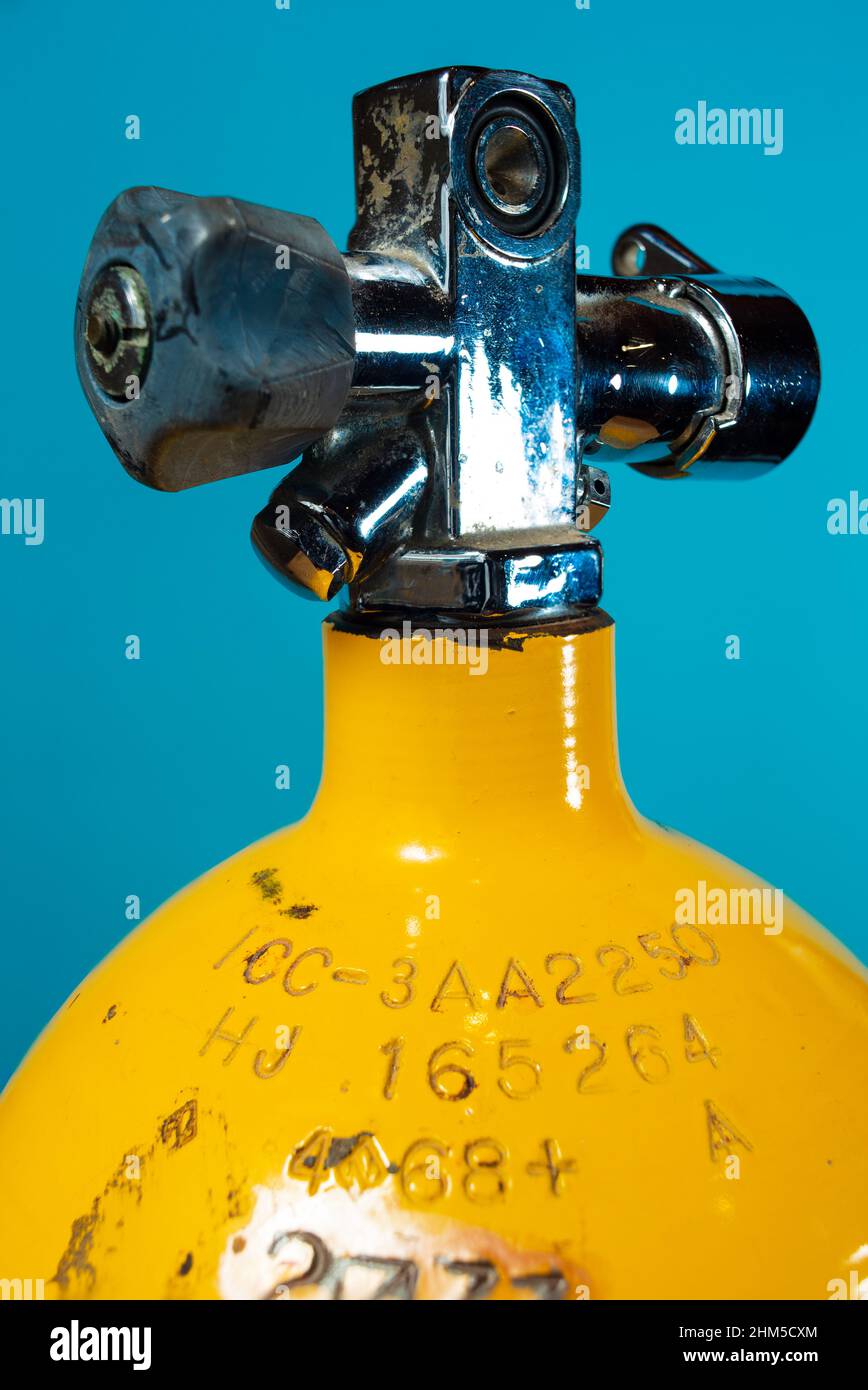 Vintage yellow steel scuba tank and valve with blue background Stock ...