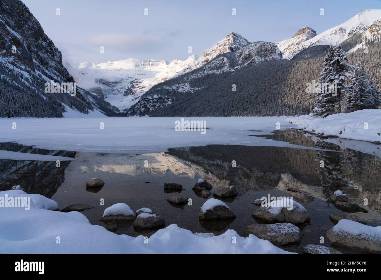 A view of a partially frozen Lake Louise in winter, Banff National Park ...