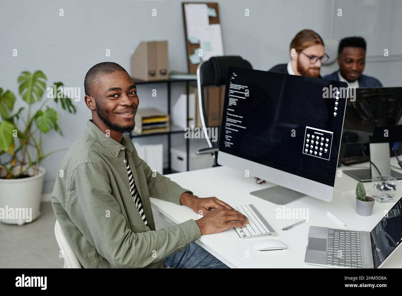 Happy young African American diversity programmer in casual clothes ...