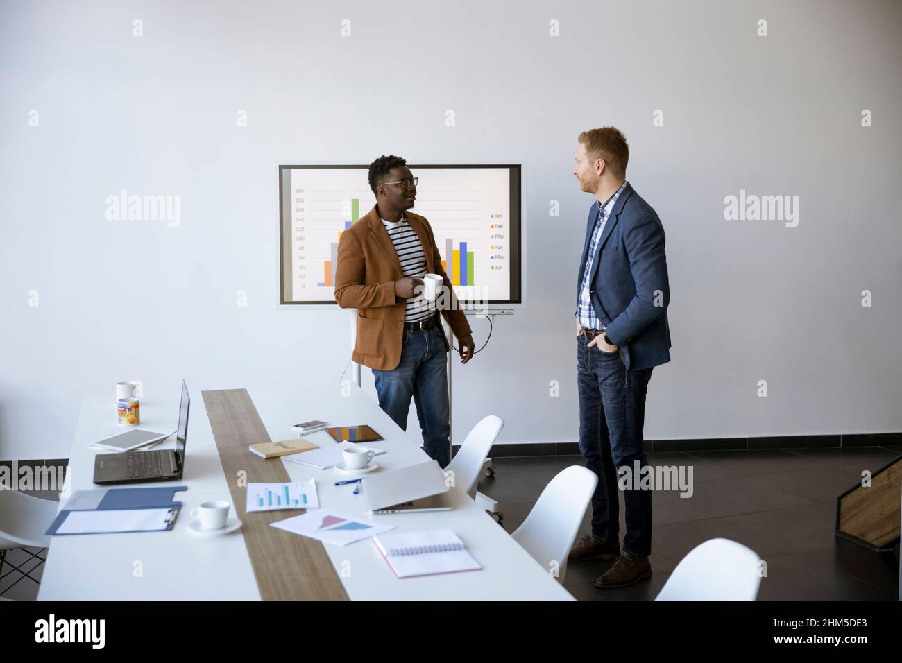 Handsome multiethnic young business men working together in the office ...
