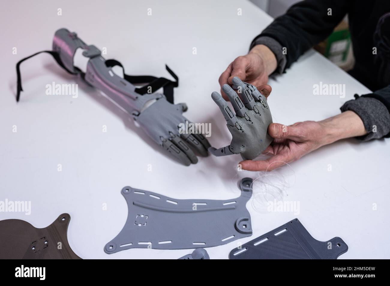 Man mounts a 3D Printed plastic arm prosthesis at Zaragoza MarketSpace ...