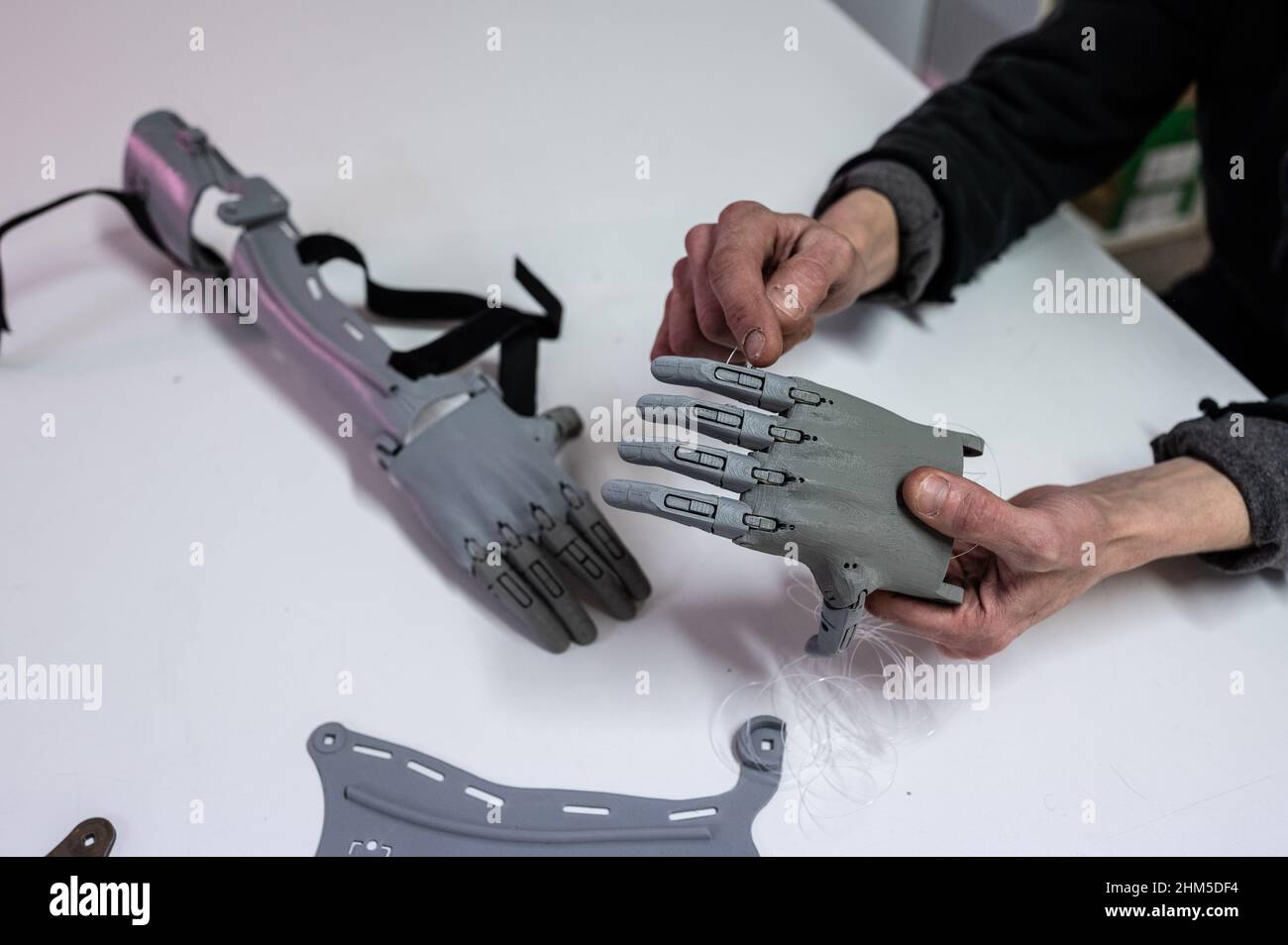 Man mounts a 3D Printed plastic arm prosthesis at Zaragoza MarketSpace ...