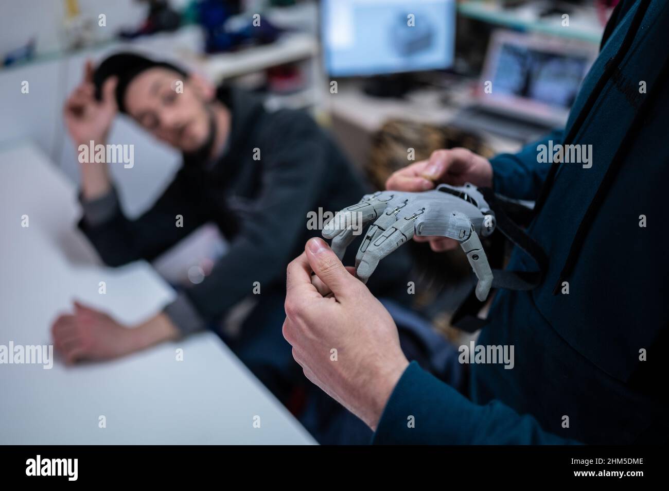 Man mounts a 3D Printed plastic arm prosthesis at Zaragoza MarketSpace ...