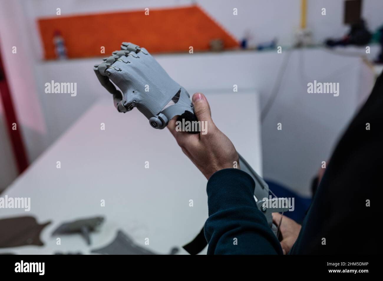 Man mounts a 3D Printed plastic arm prosthesis at Zaragoza MarketSpace ...