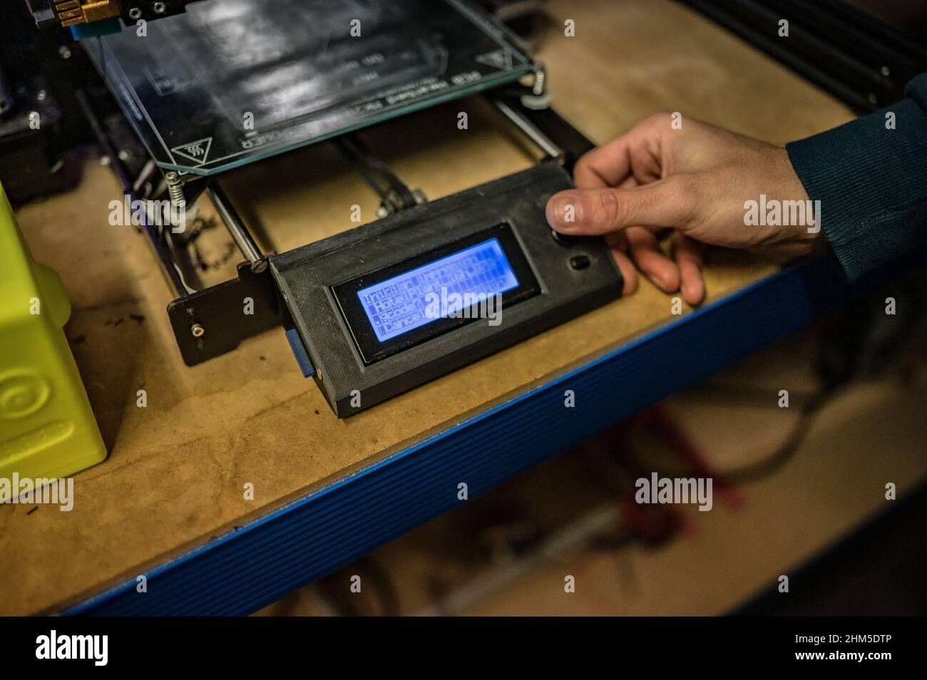 Man controlling a 3D Printer through the touching display screen Stock ...