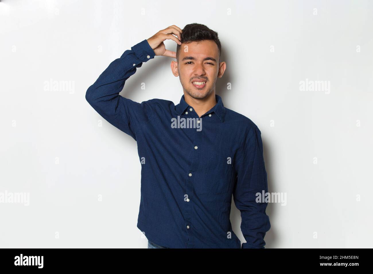 Young handsome business man scratching head with hand isolated on white ...