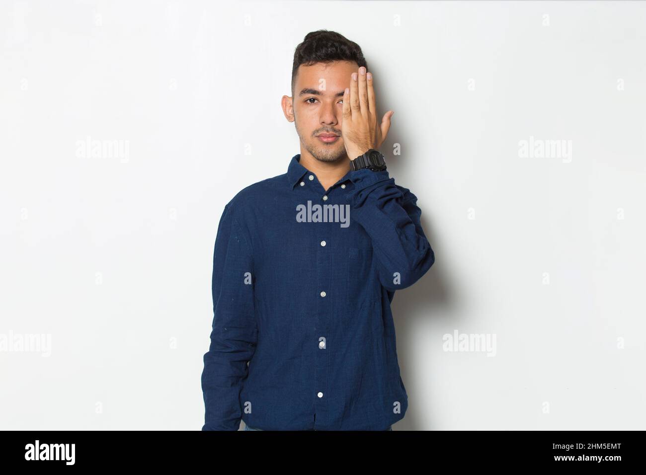 Young handsome business man covering one eye with hand isolated on ...