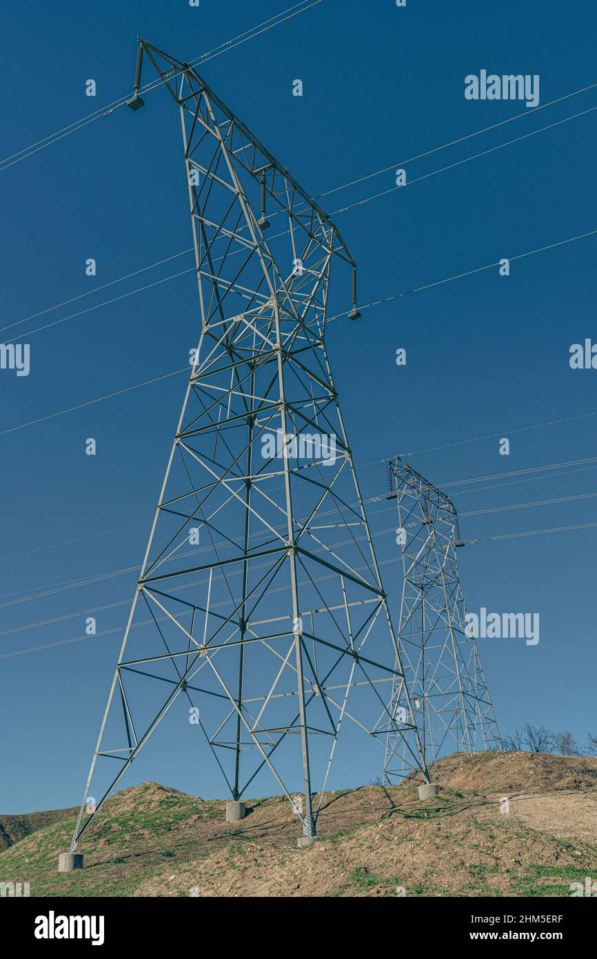 Vertical shot of the high voltage transmission tower under the clear ...