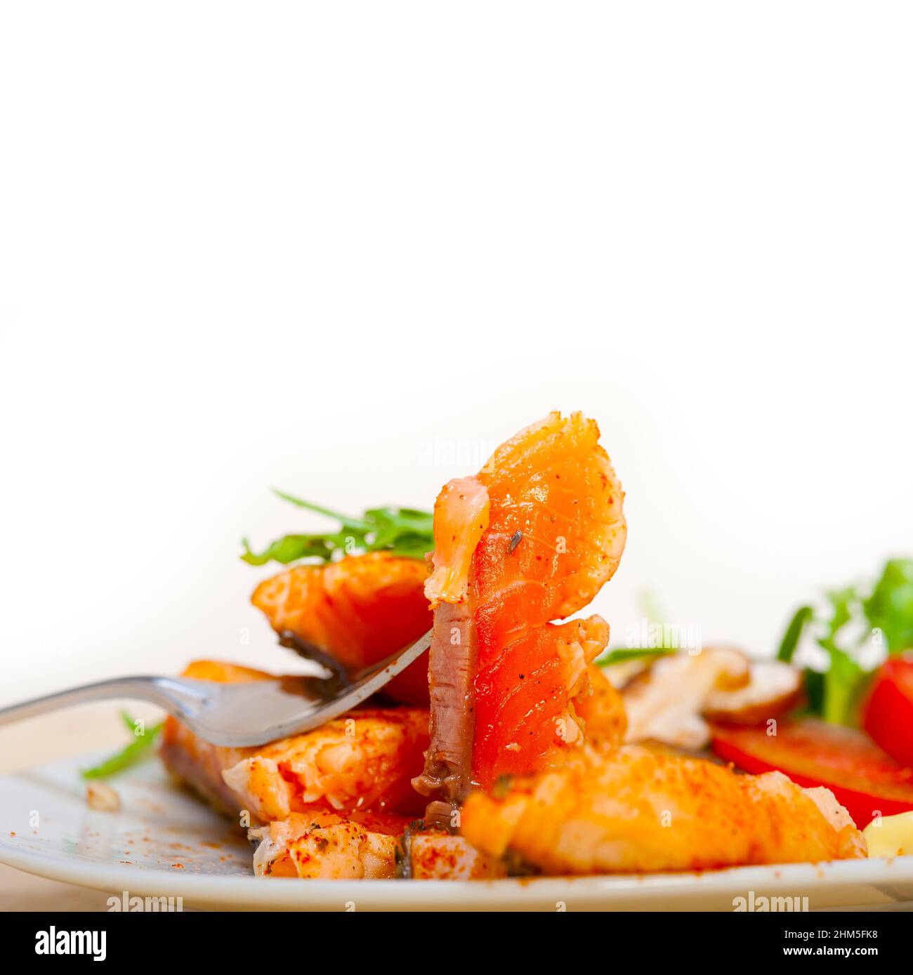 grilled fresh samon filet with vegetables salad tomato arugula ...