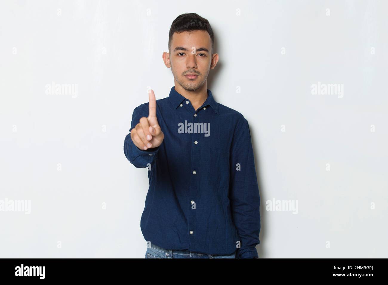 Handsome young business man with open hand doing stop sign with serious ...