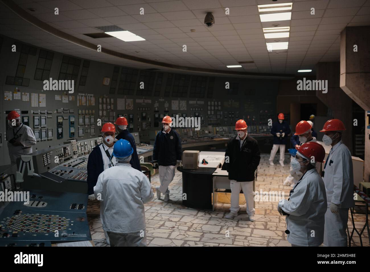 A tour group listens to the guide in control room 3 at the Chernobyl ...