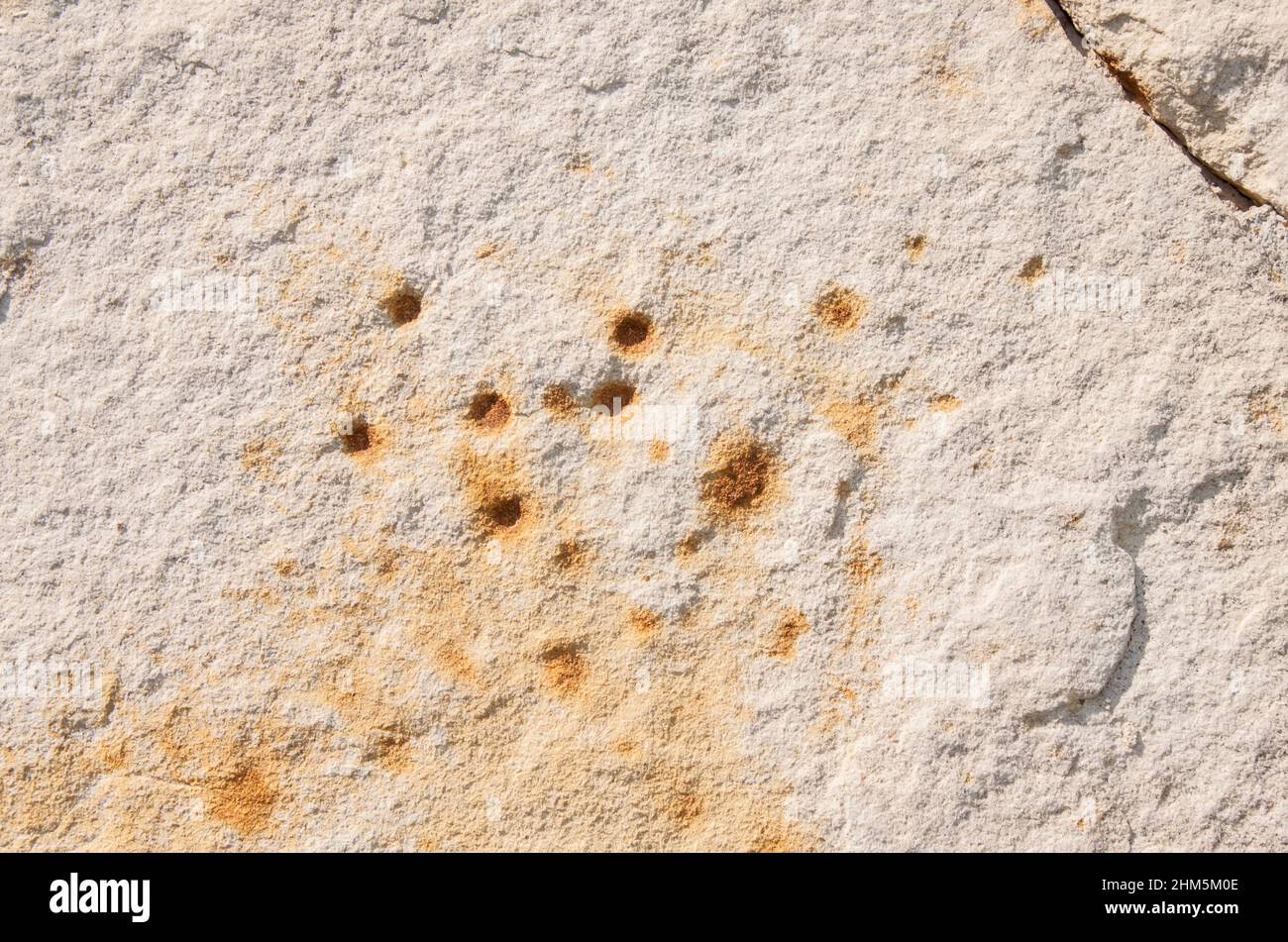 A closeup view of stone texture with holes made by water drops Stock ...