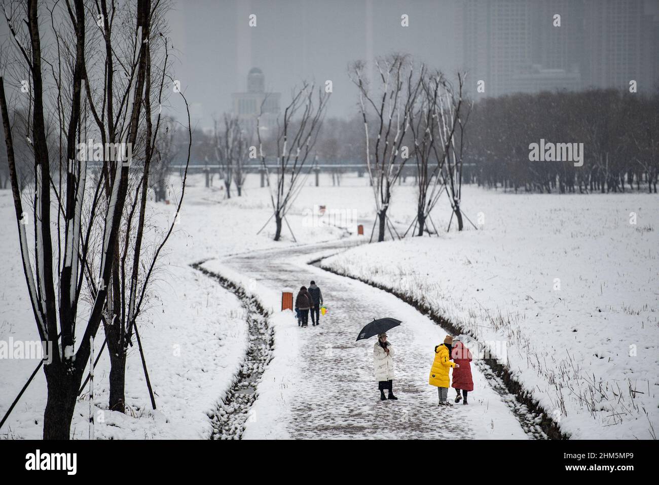Wuhan, China. 07th Feb, 2022. People walk in the Jiangtan park during a ...