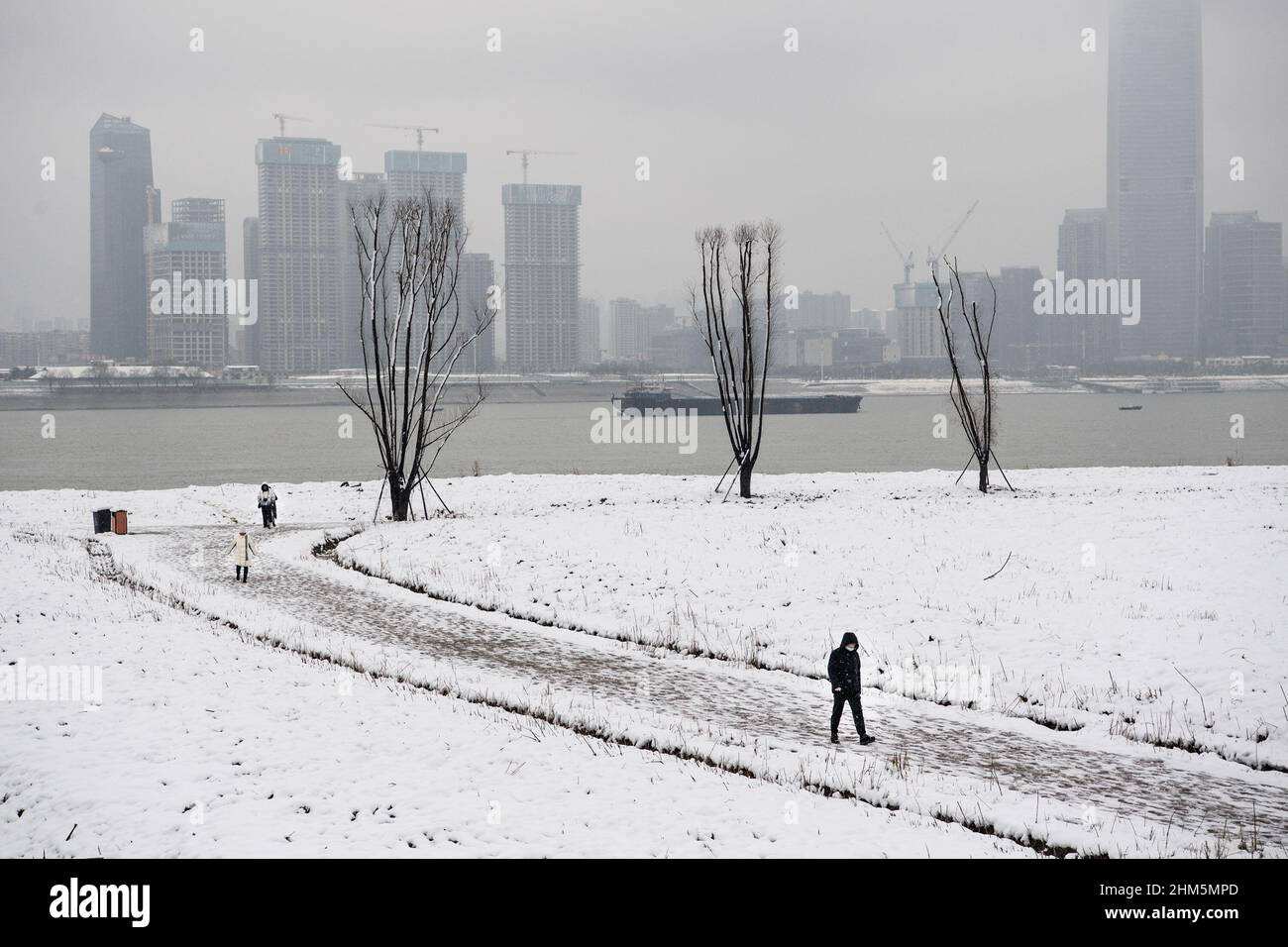 Wuhan, China. 07th Feb, 2022. A man walks in the Jiangtan park during a ...