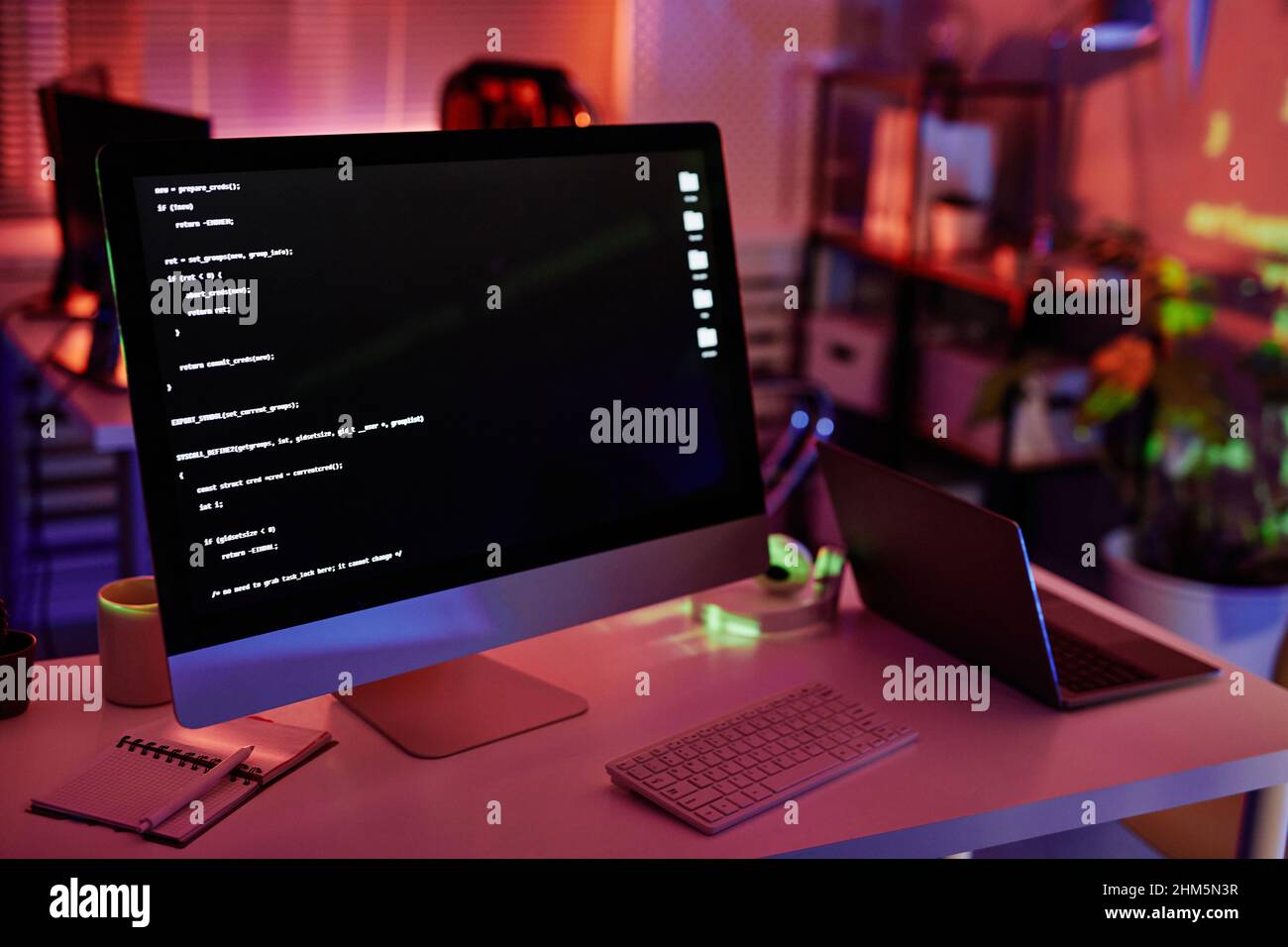 Computer monitor with decoded data on screen standing next to laptop on ...