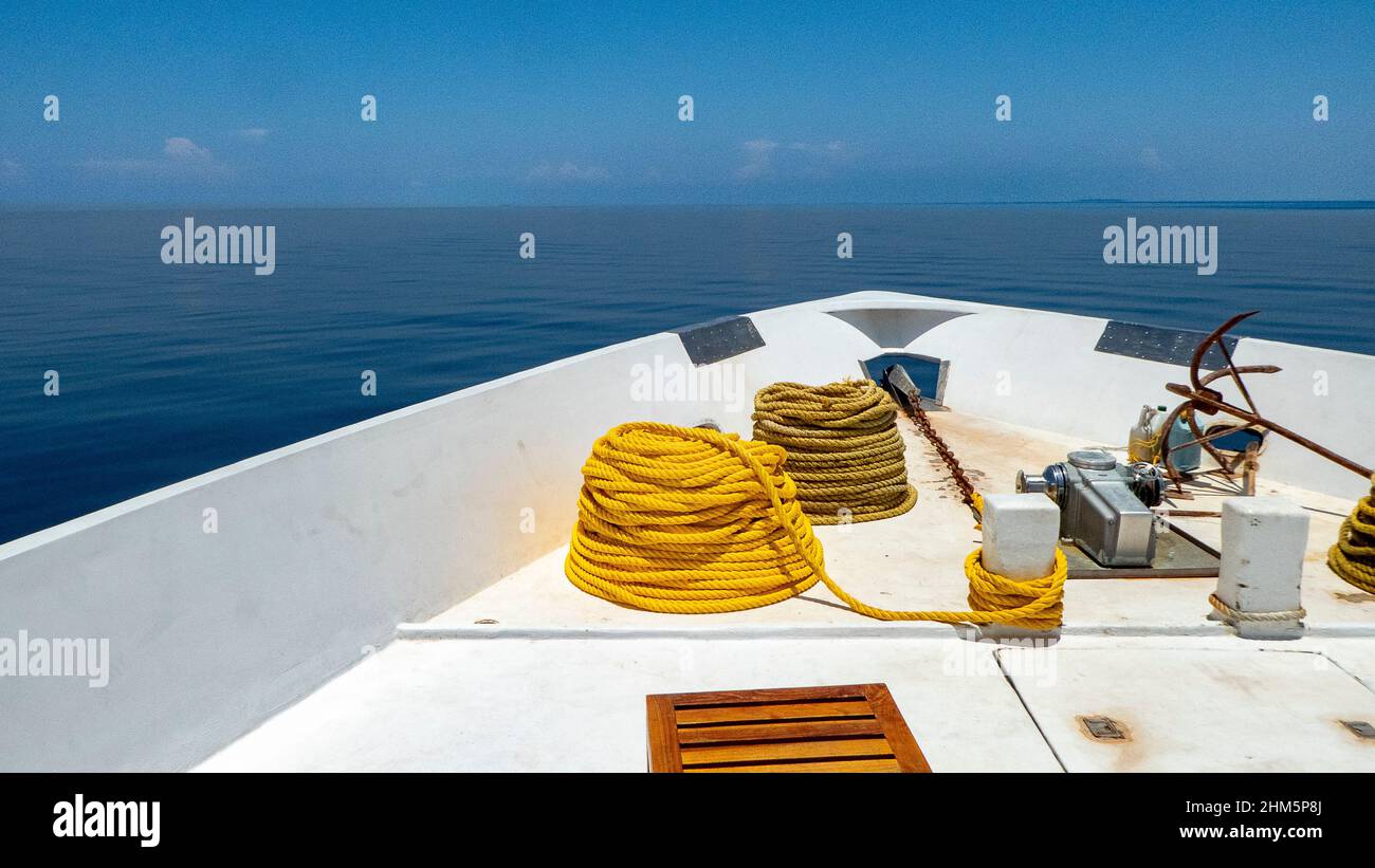 View towards the bow of ropes and an anchor on a lveaboard boat in the ...