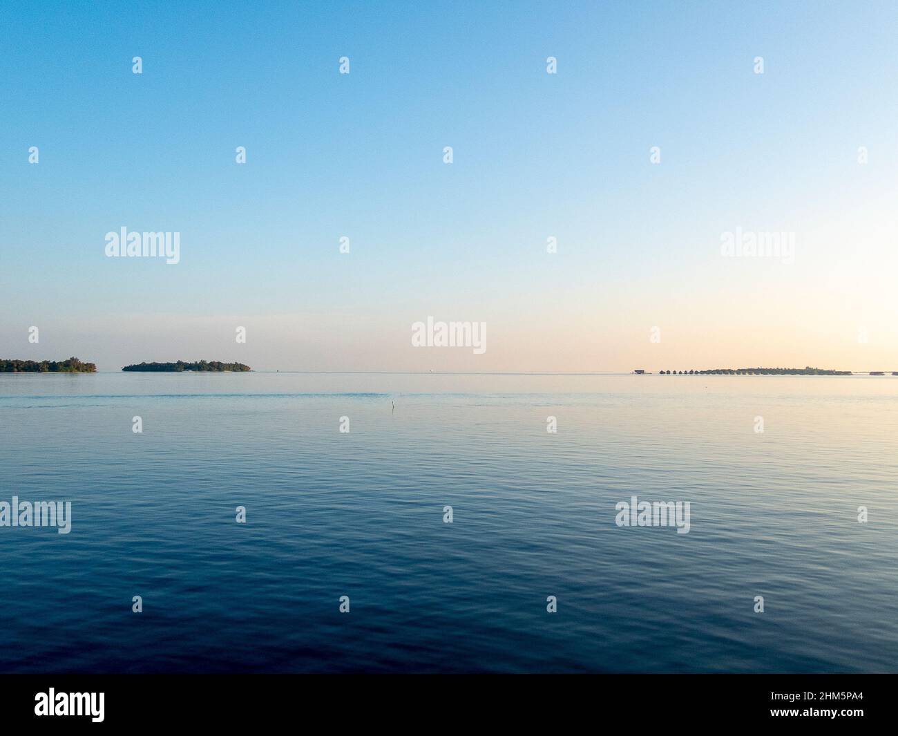 Tranquil image of the Indian Ocean and distant islands at dusk in the ...