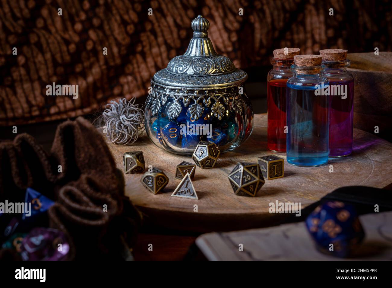 Image of magical potions and a glass pot with RPG dice on a wooden ...