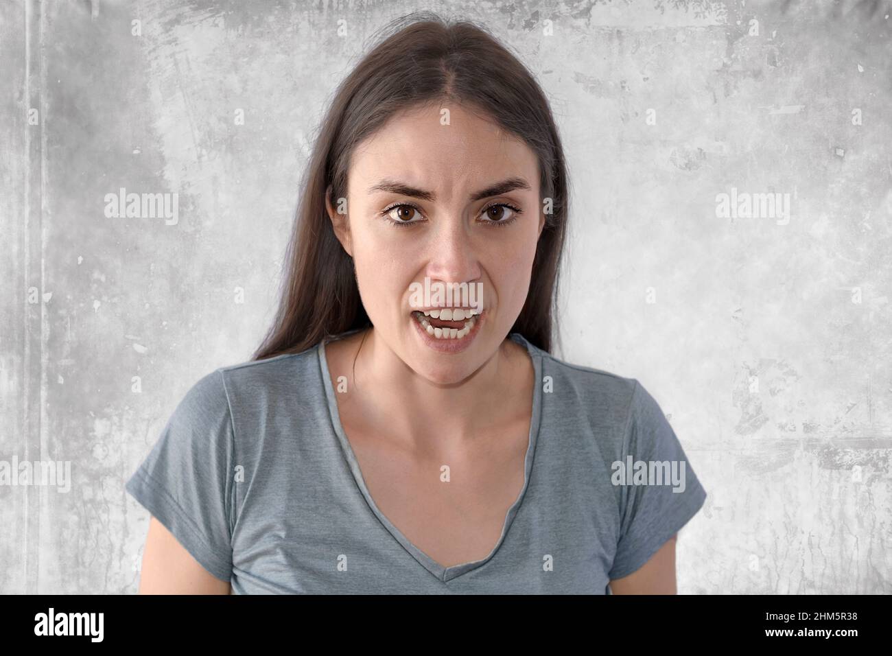 Angry woman screaming on a white concrete background hi-res stock ...