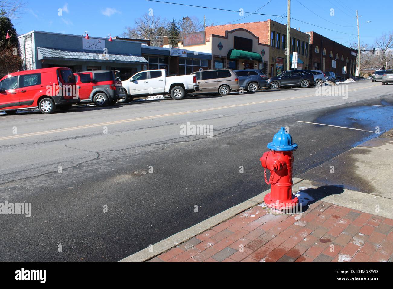 Red and blue fire hydrant on small town street Stock Photo - Alamy
