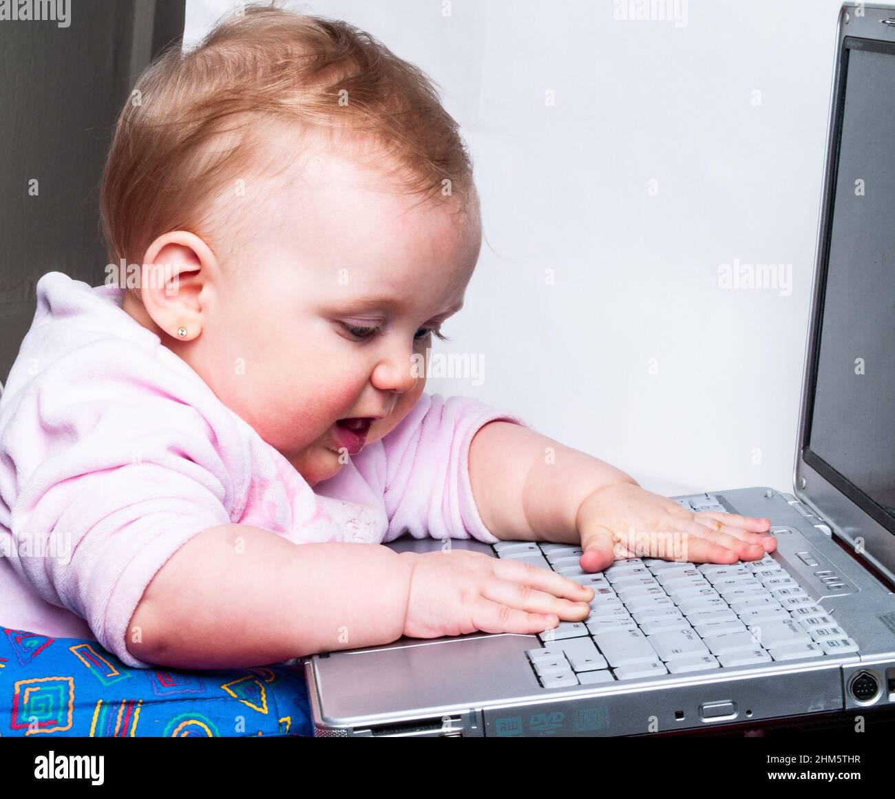 Baby playing on laptop keyboard Stock Photo - Alamy