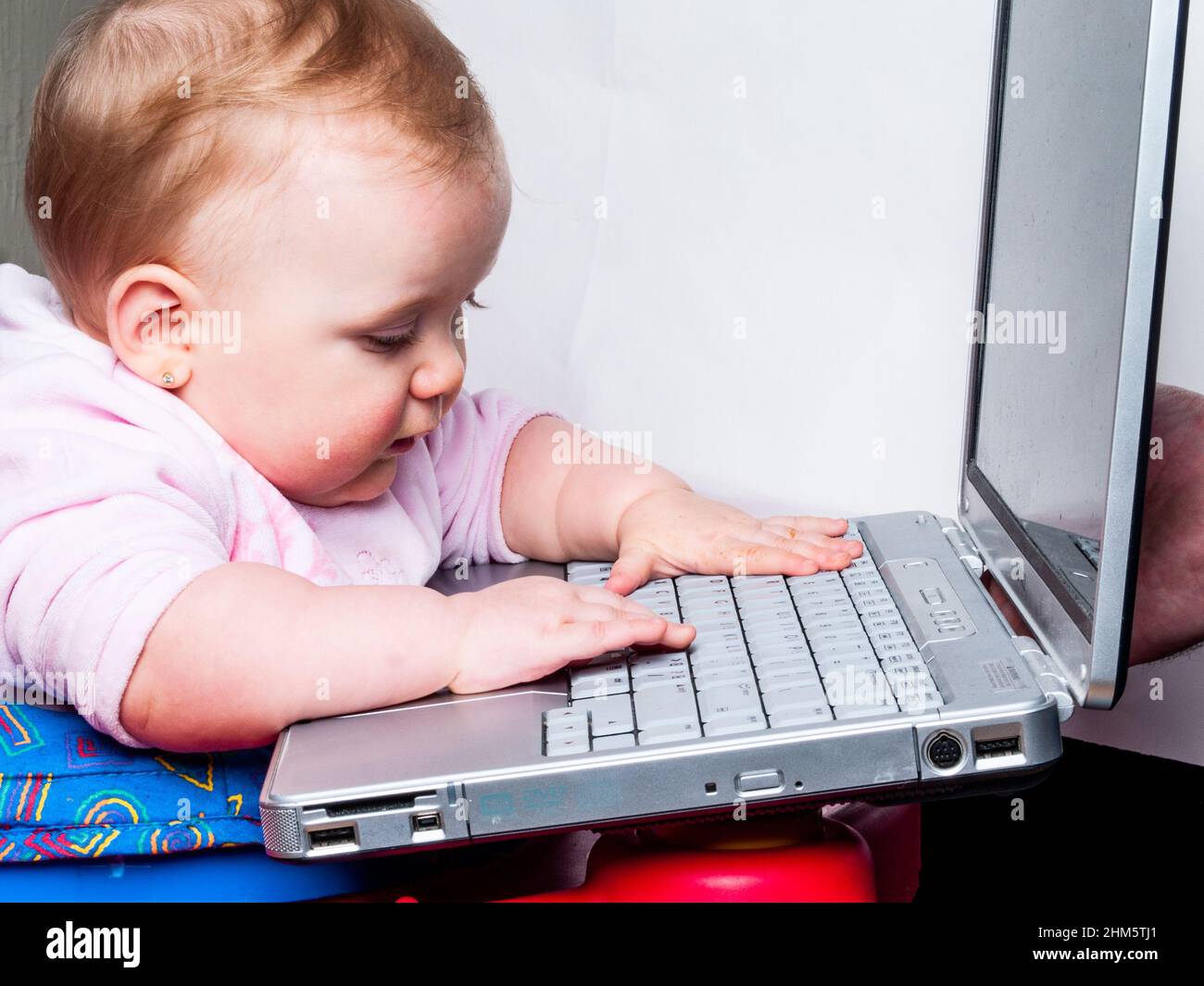 Baby playing on laptop keyboard Stock Photo - Alamy