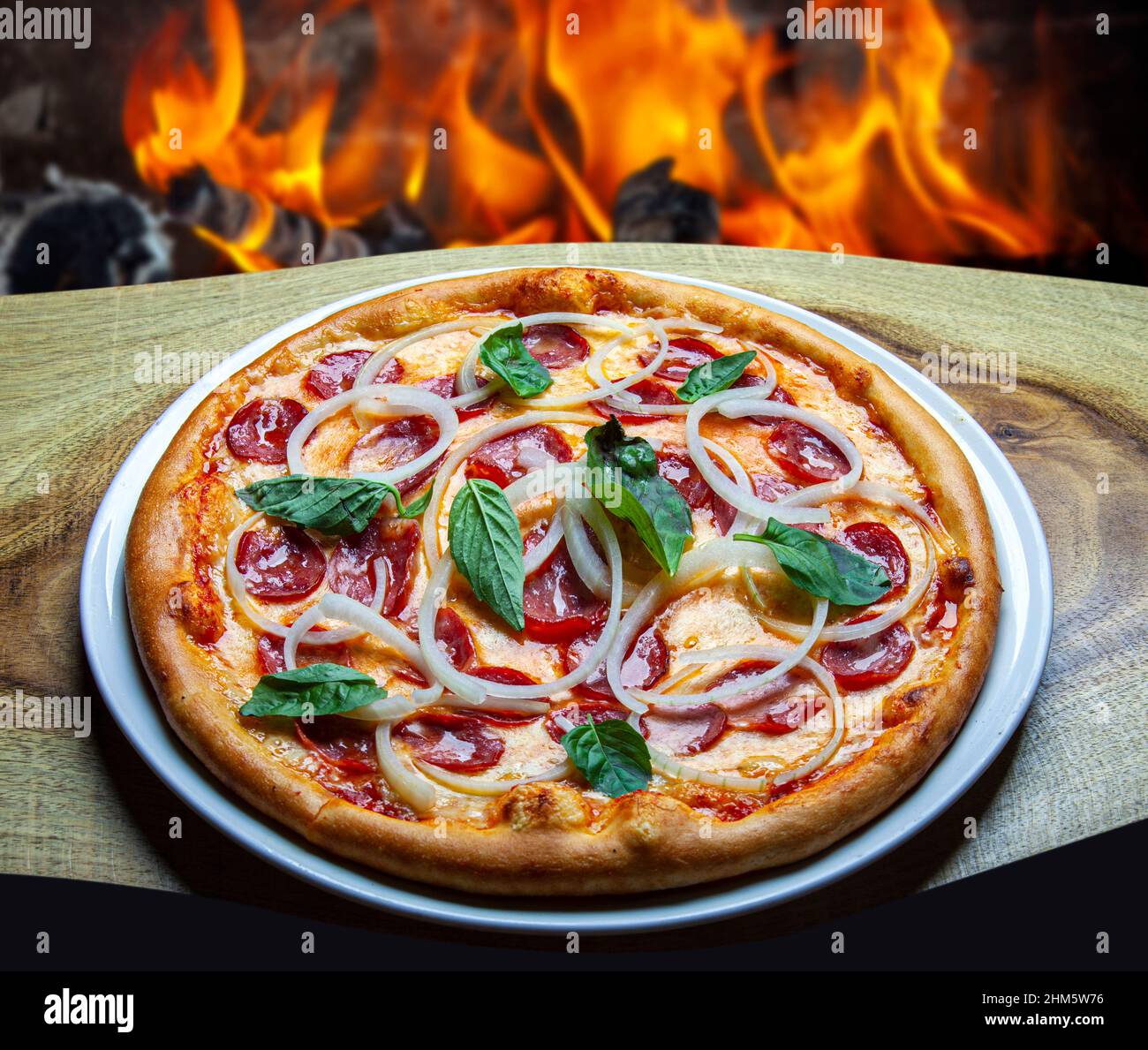 Pepperoni pizza with onion rings Stock Photo - Alamy