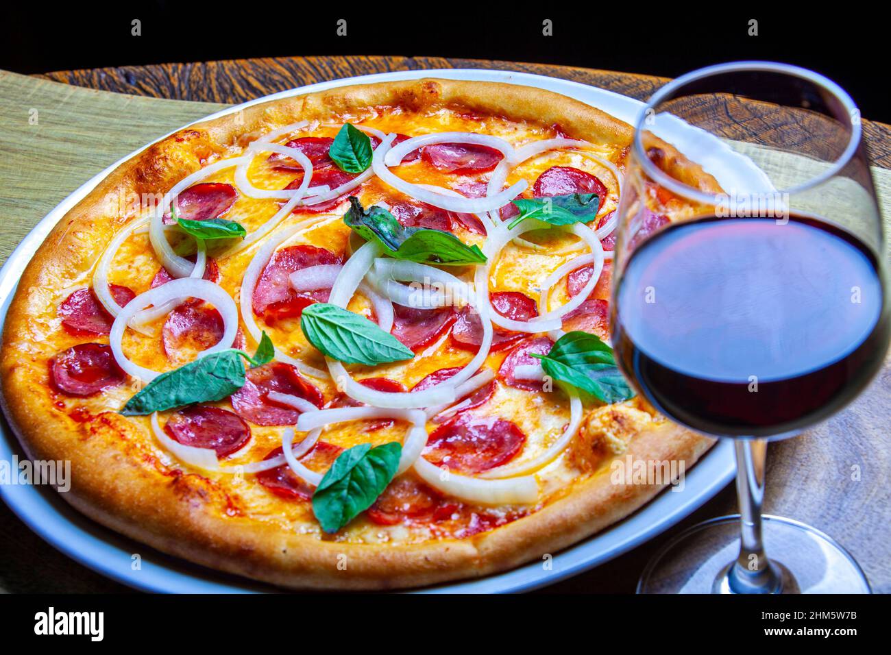 Pepperoni pizza with onion rings Stock Photo - Alamy