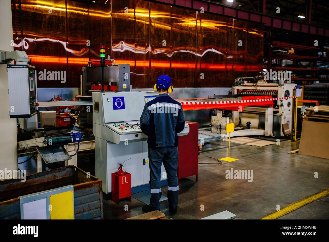 Factory worker operating CNC machine in metalworking workshop Stock ...
