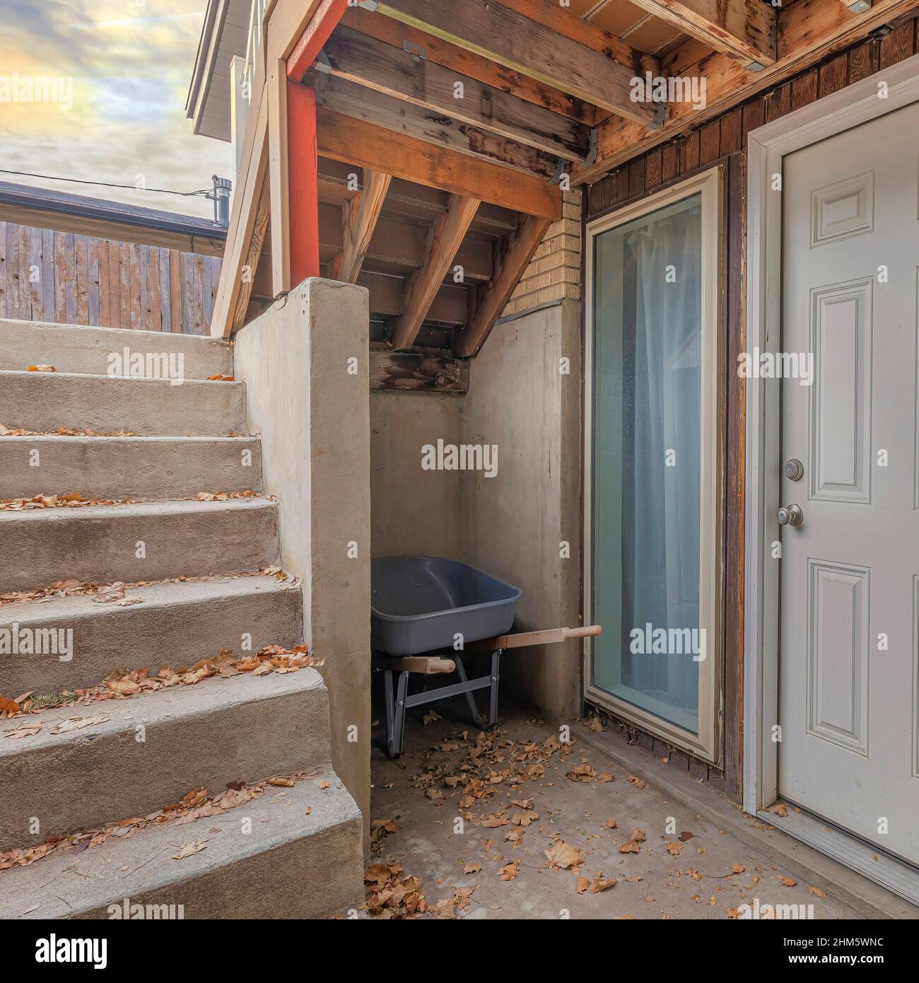 Square Puffy clouds at sunset Basement white front door with scattered ...
