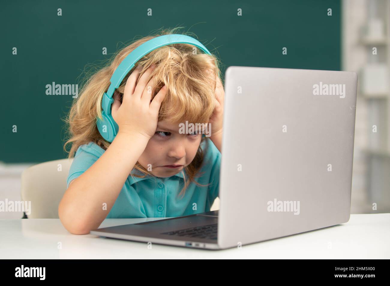Angry sad child using laptop computer, kid boy studying through online ...