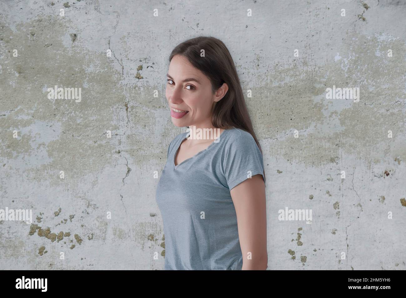 Naughty girl misbehaving, sticking out her tongue at camera as a sign ...