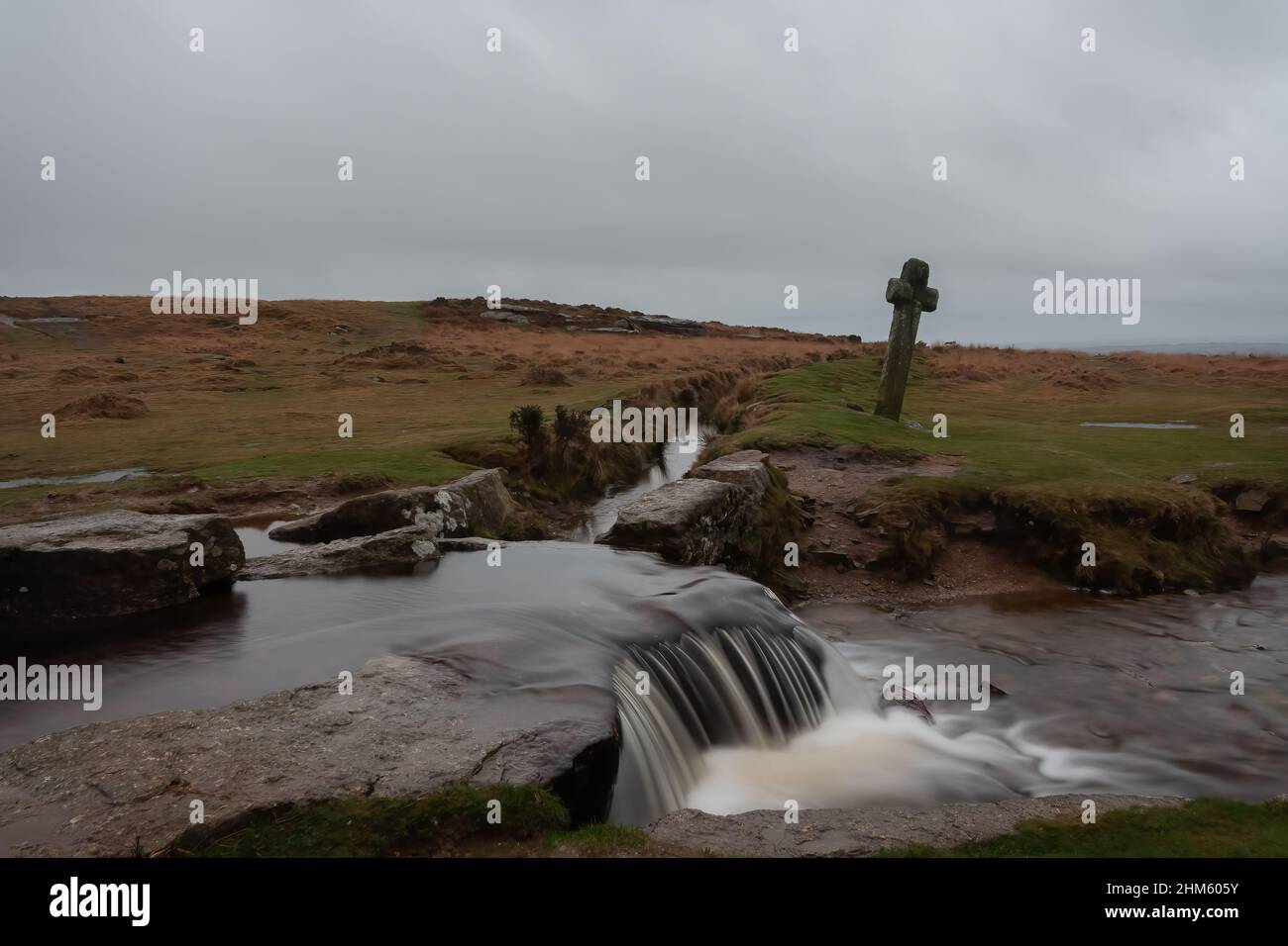 Windy Post, a tilted granite cross standing on moorland alongside a ...