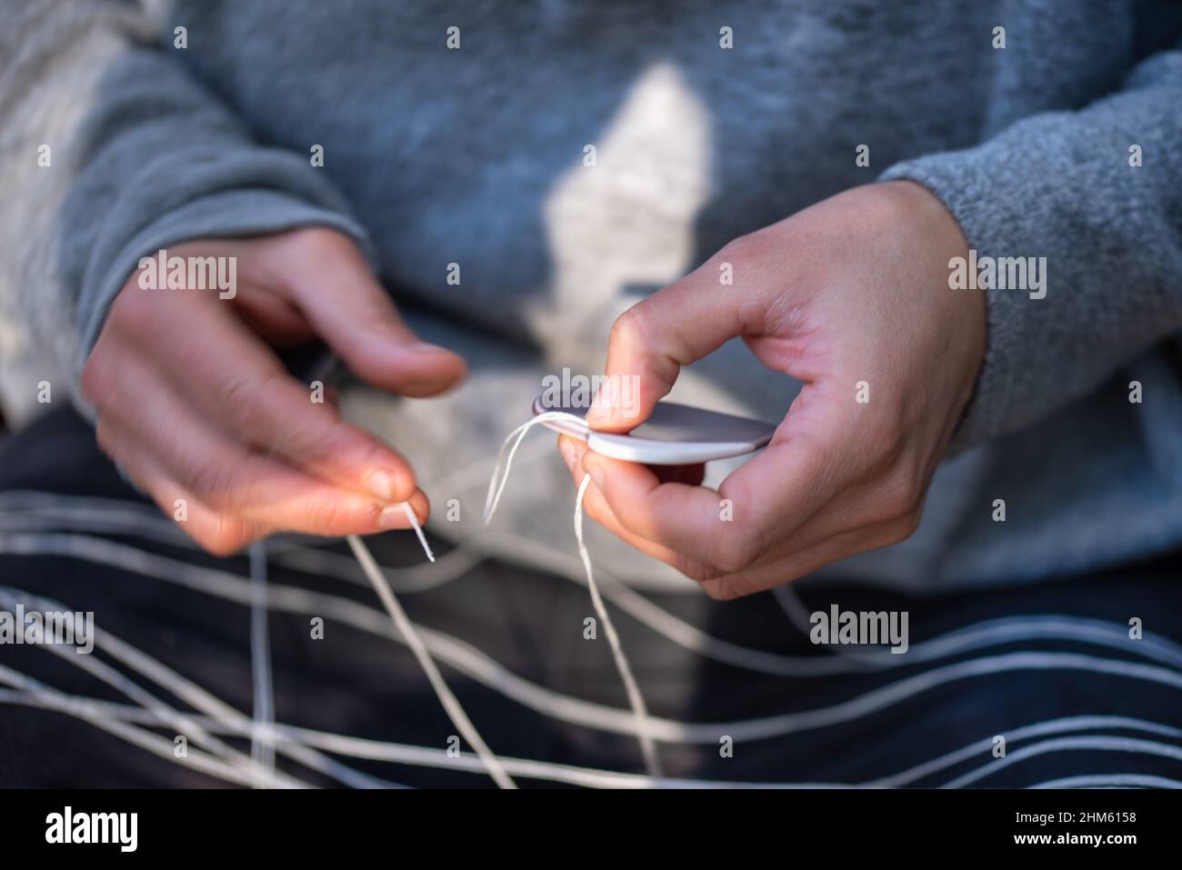 hands making crafts white string lines and ceramic Stock Photo - Alamy