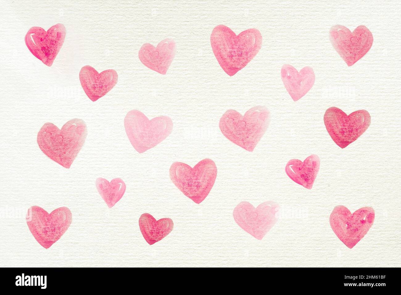 Love background with many watercolor hearts painted on a recycled white ...