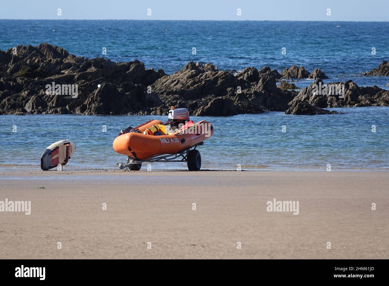 An RNLI RIB or rigid inflatable boat on a trailer on a beach in the UK ...