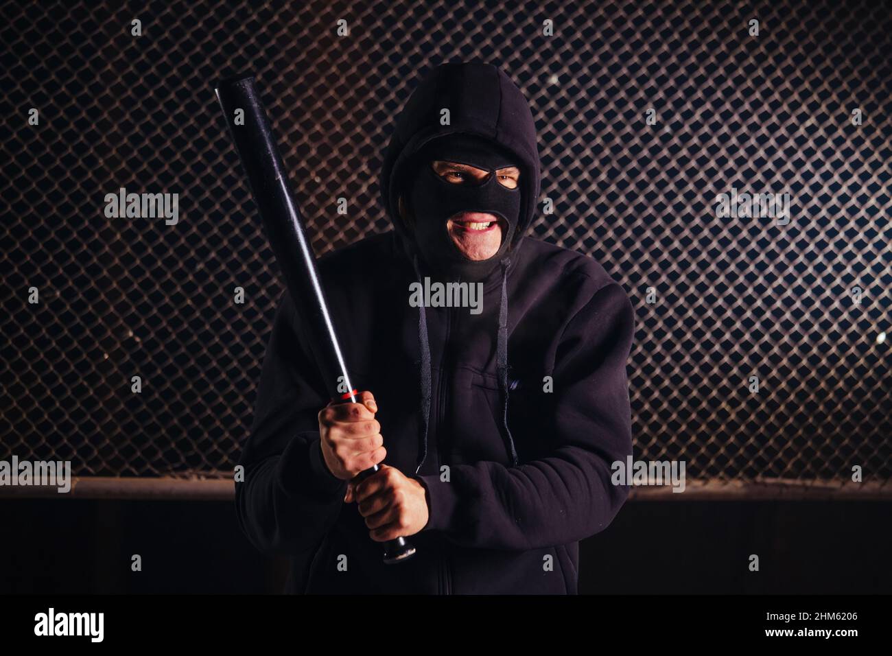 Masked angry man with bat. Hooligan concept Stock Photo - Alamy